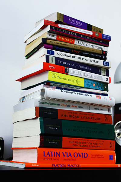 A photograph of a stack of college text books