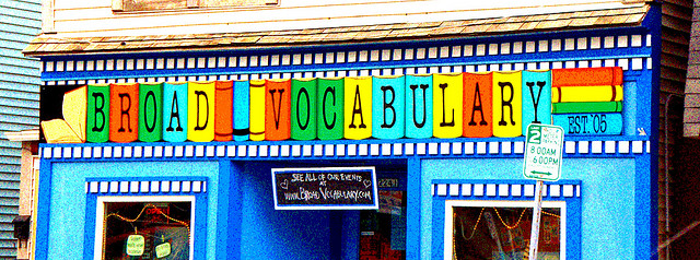 An outdoor photograph of a book store sign that reads “Broad Vocabulary”